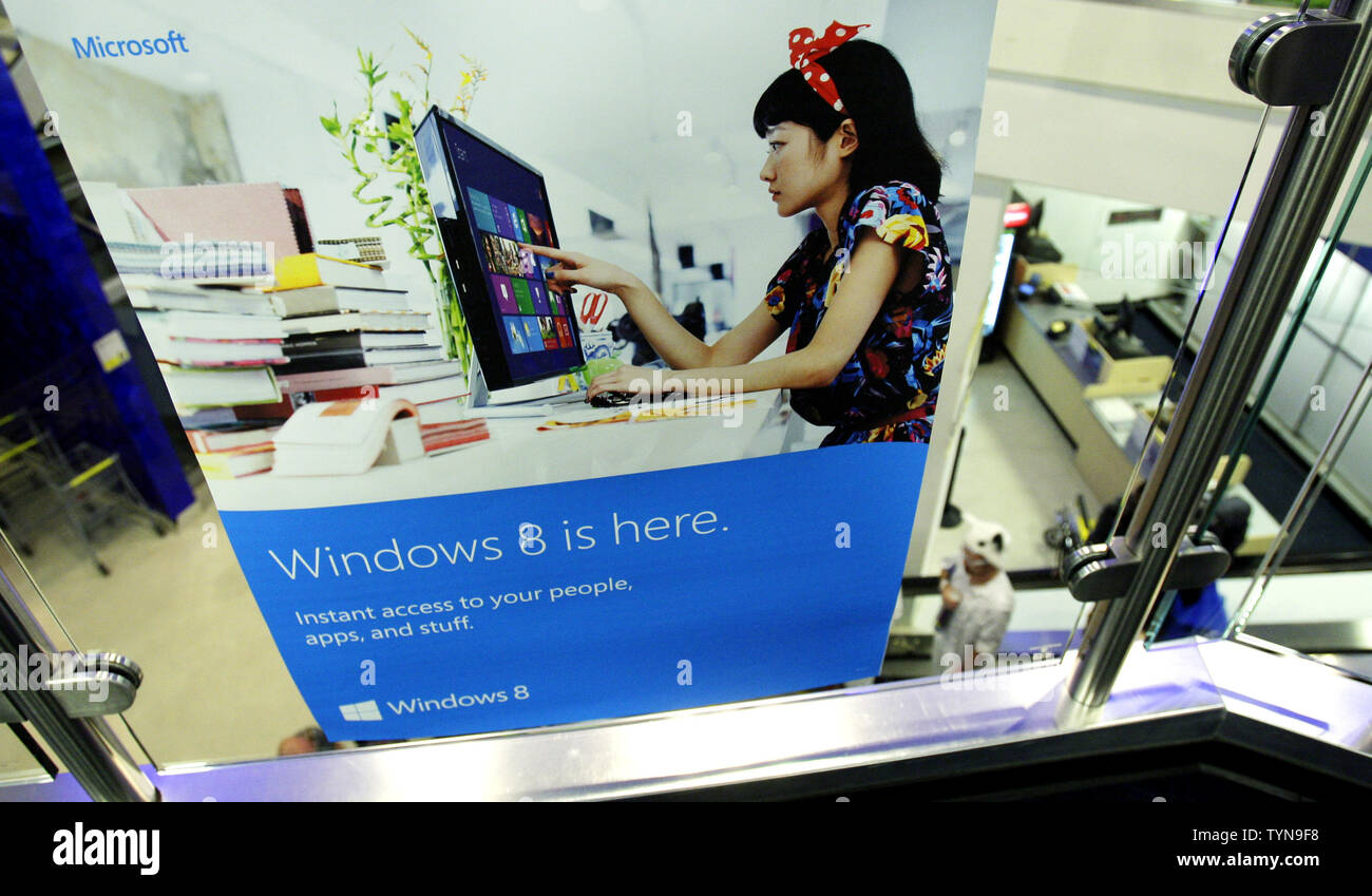 A sign at a retail store displays the new Microsoft Windows 8 operating system on the day of its ...