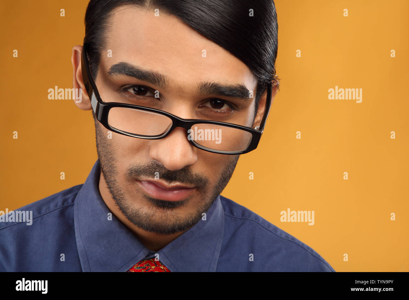 Indian man looking over eyeglasses hi-res stock photography and images ...