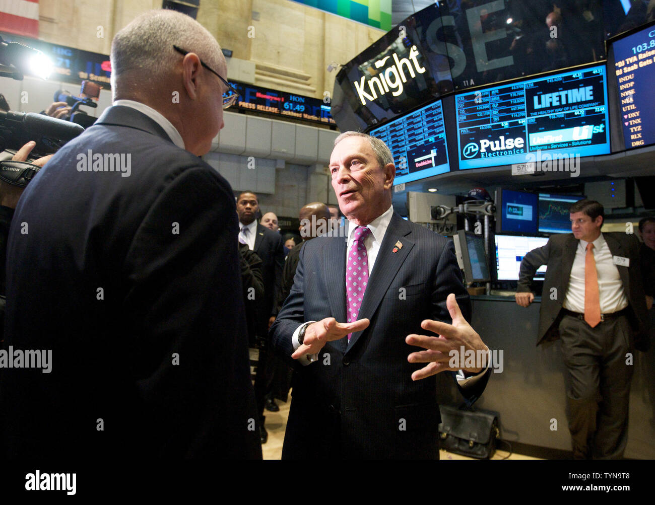 New York City Mayor Michael Bloomberg (R) talks with a trader as the ...