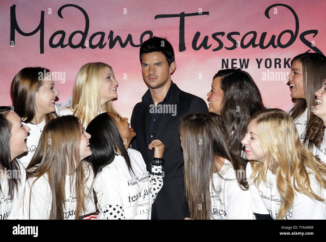 A group of girls gather around a wax figure of Taylor Lautner when it ... A group of girls gather around a wax figure of Taylor Lautner when it ...