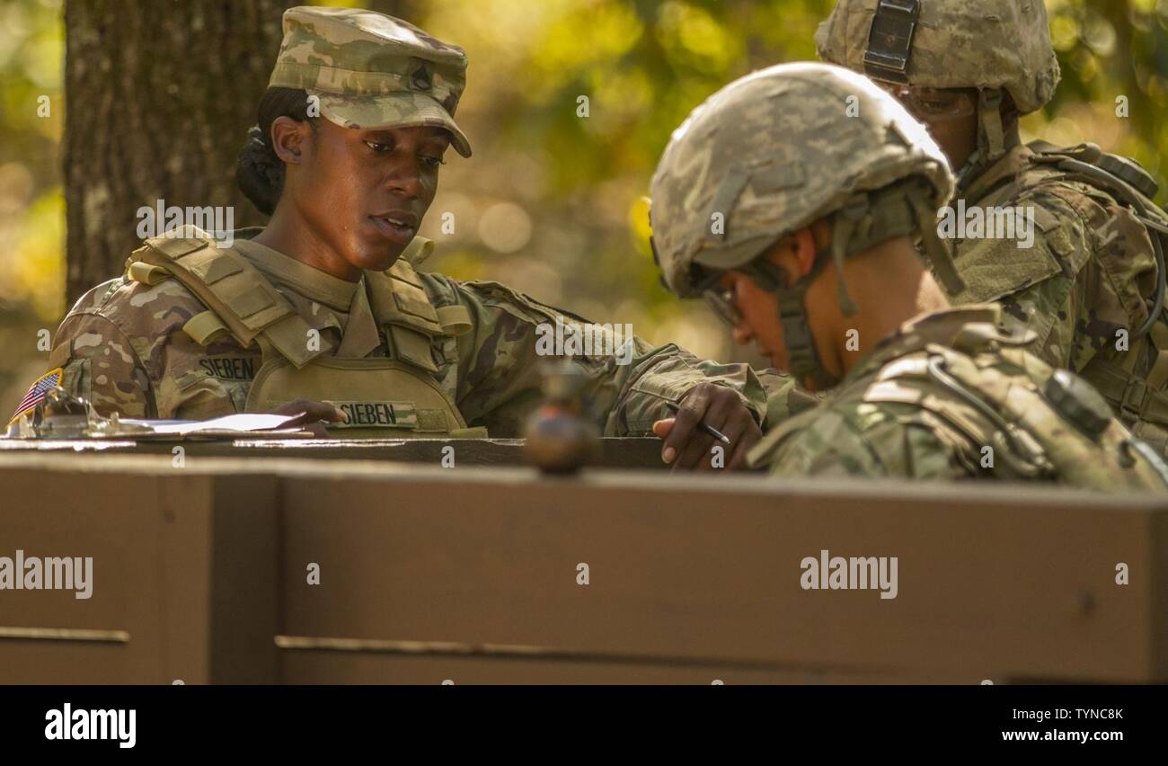Army Drill Sergeant, Staff Sgt. Akia Sieben assist Pvt. Diego Garcia ...