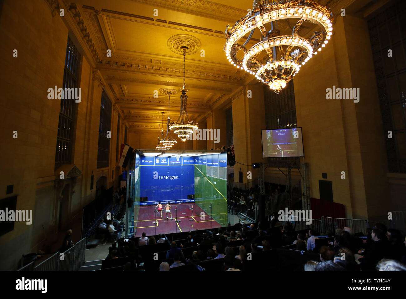 Spectators watch a squash tournament at the 16th anniversary of the ...