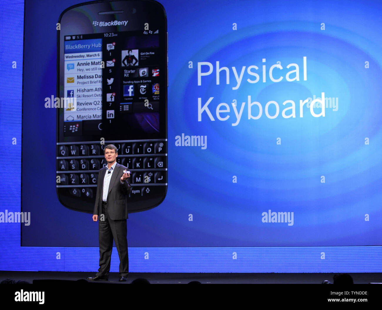 RIM CEO Thorsten Heins holds up a Blackberry Q10 at the launch event ...