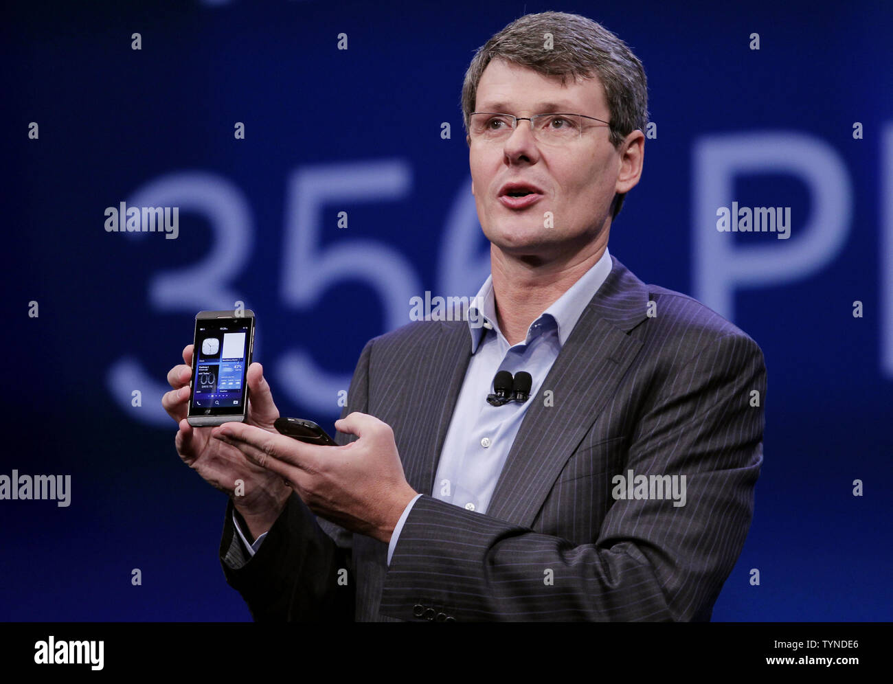 RIM CEO Thorsten Heins holds up a Blackberry Z10 at the launch event ...