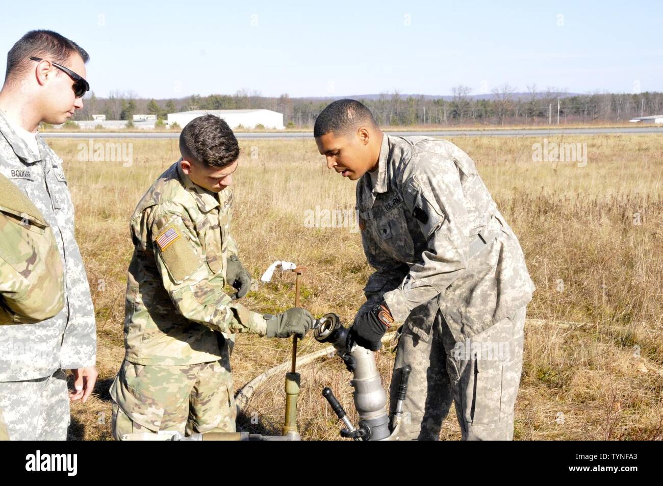 U.S. Army Spc. Justin Rush, right, petroleum supply specialist with ...