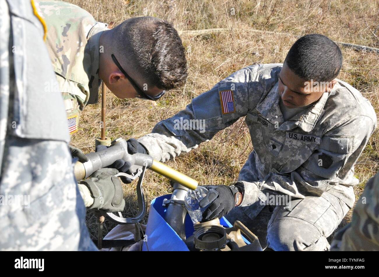 U.S. Army Spc. Justin Rush, right, petroleum supply specialist with ...