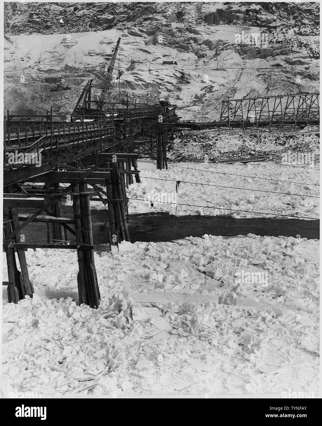 Upstream view of contractor's trestle showing the accumulation of ice ...