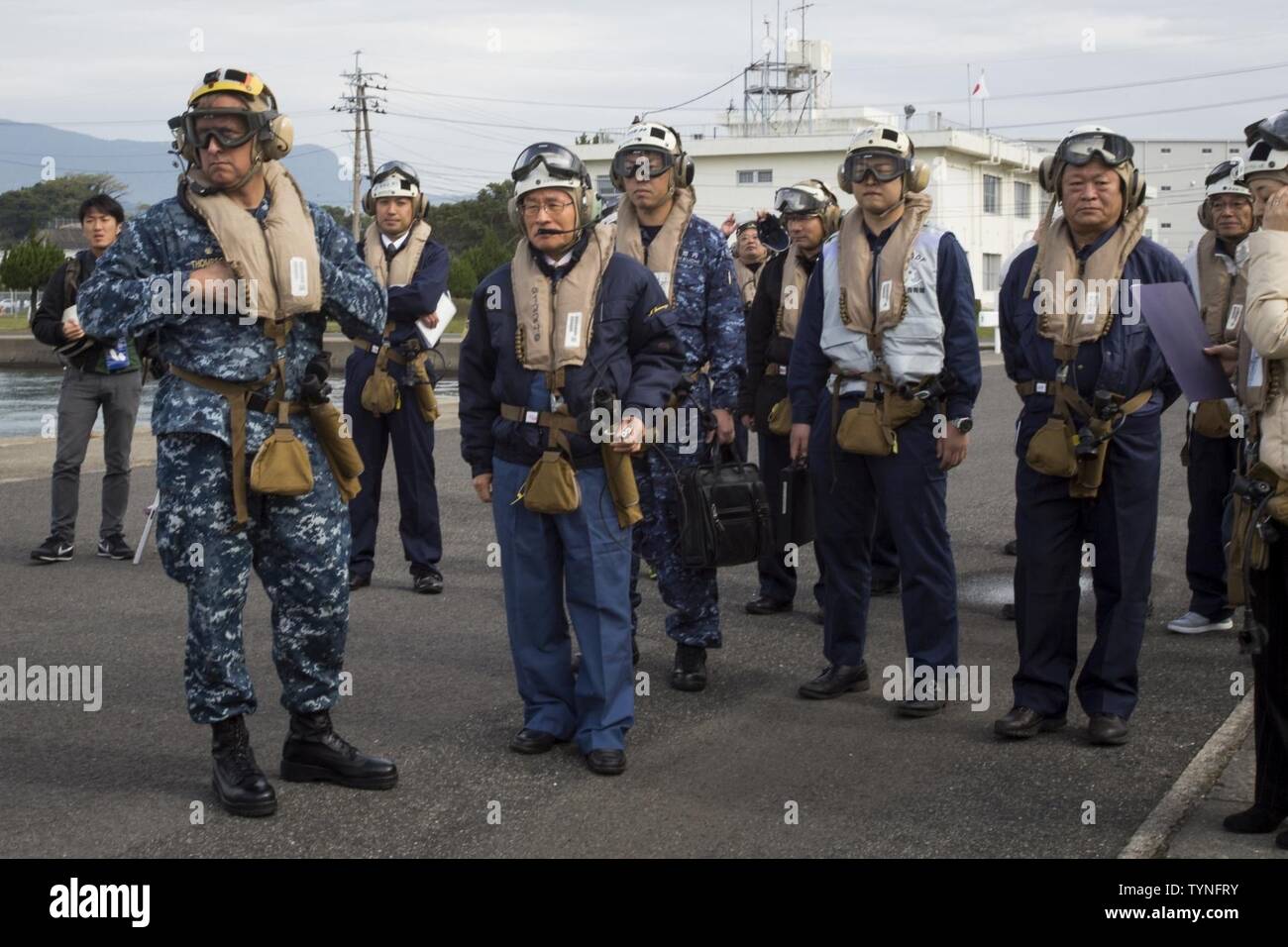 Navy Capt. Ed Thomson, commander of Amphibious Squadron 11; Mr. Norio ...
