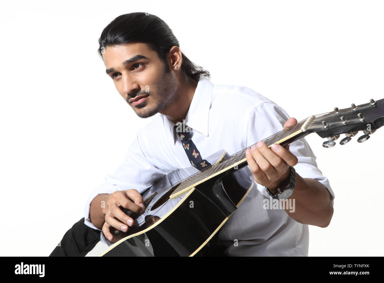 Indian man playing guitar Stock Photo - Alamy
