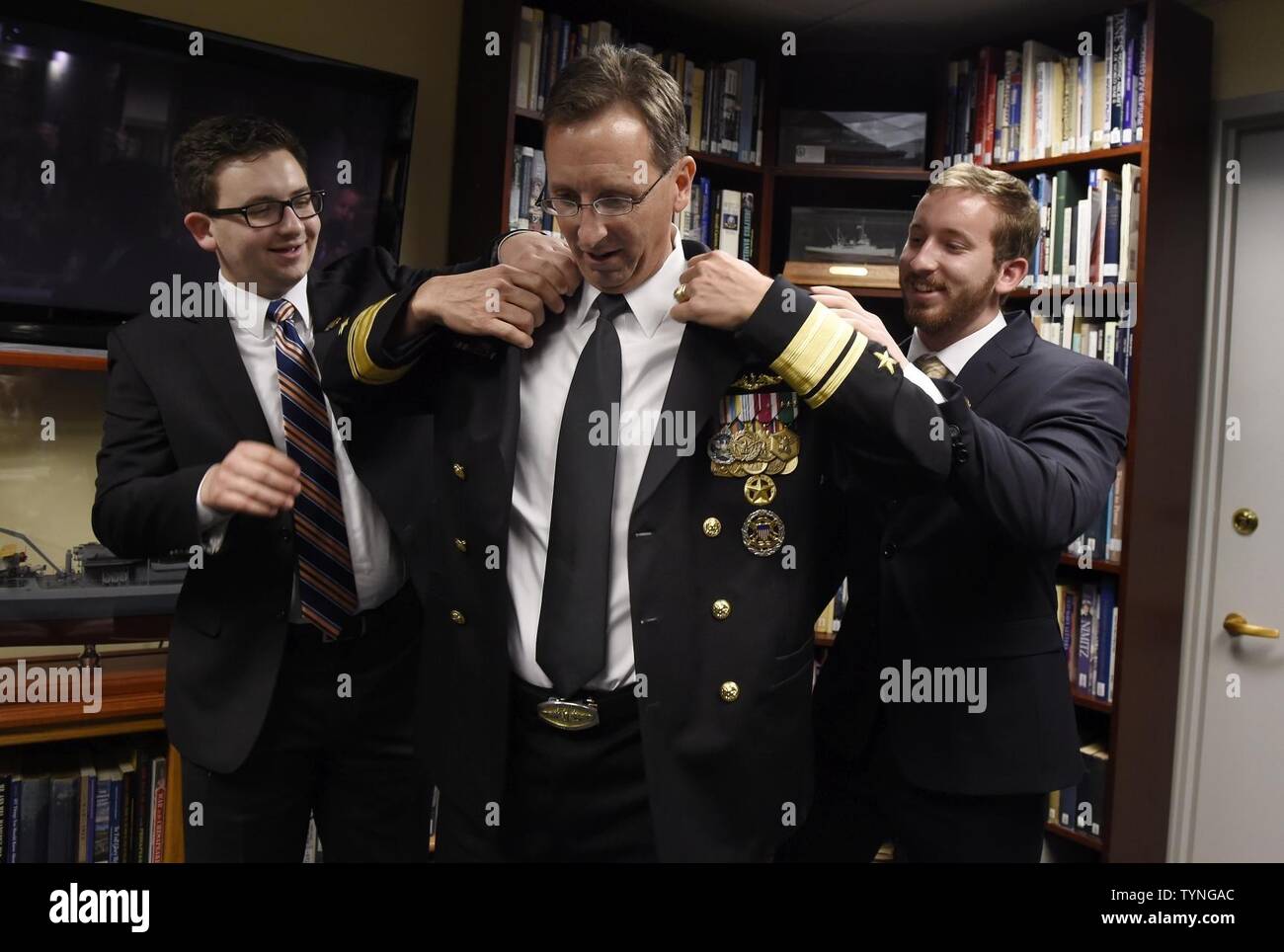 WASHINGTON (Nov. 18, 2016) Rear Adm. David J. Hahn gets assistance from ...