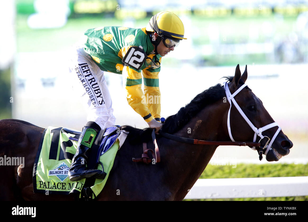 Mike E. Smith riding horse Palace Malice crosses the finish line and ...