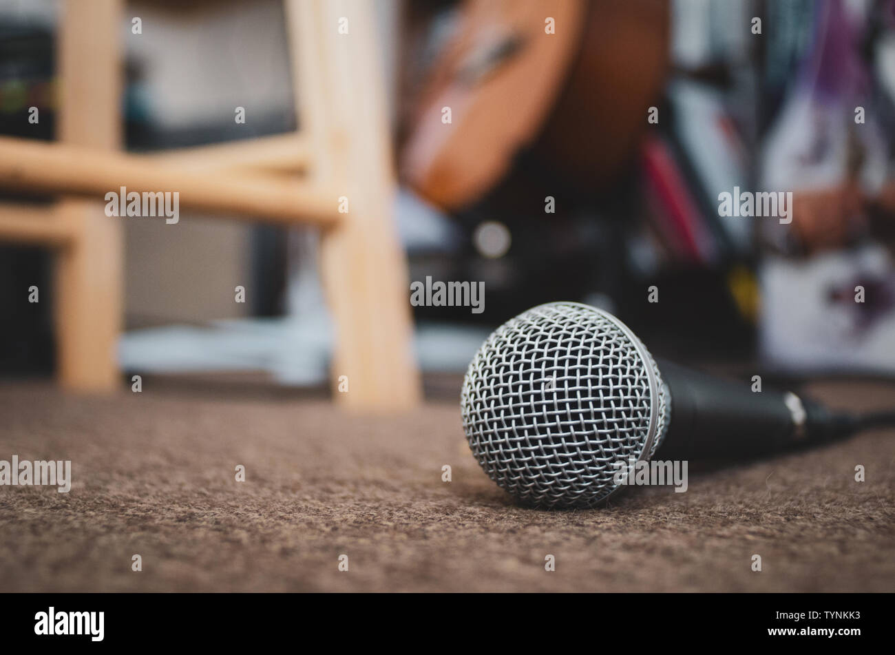 Microphone on carpeted floor with copy space. A microphone lying on the ...