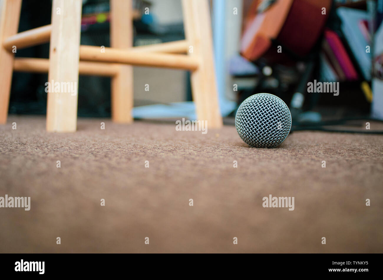 Microphone on carpeted floor with copy space. A microphone lying on the ...