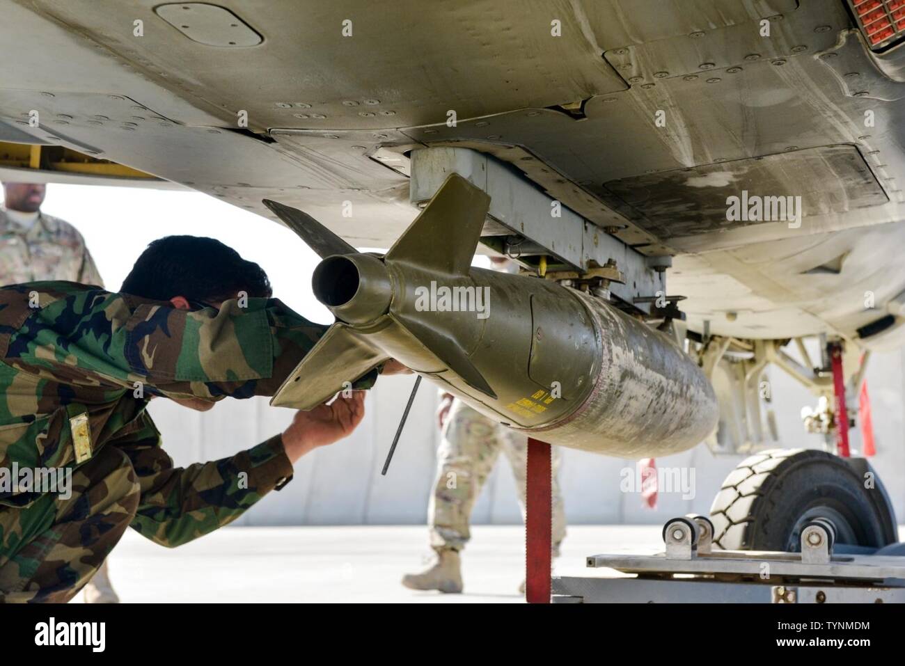 Train, Advise, Assist Command-Air (TAAC-Air) munitions air advisors watch as members of the ...
