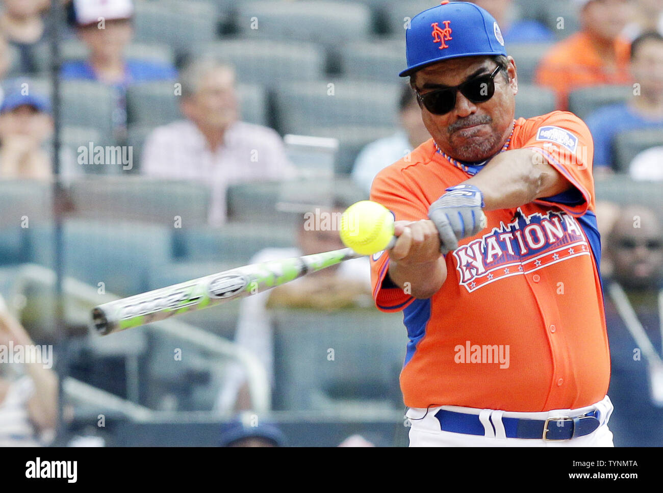 George Lopez takes a swing at a ball at the All-Star Legends ...