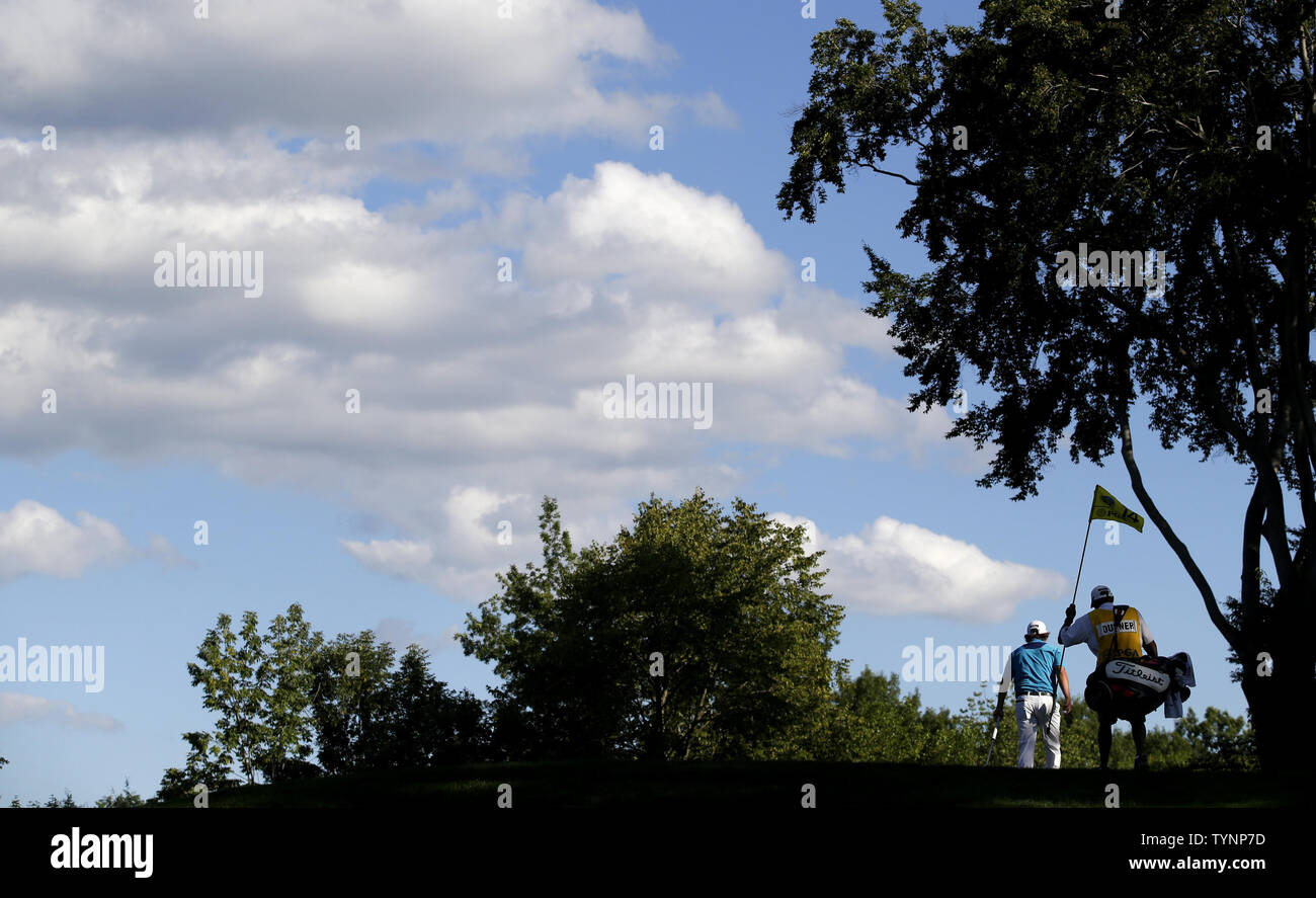 Jason Dufner and caddie Kevin Baile walk off of the 14th green in the ...