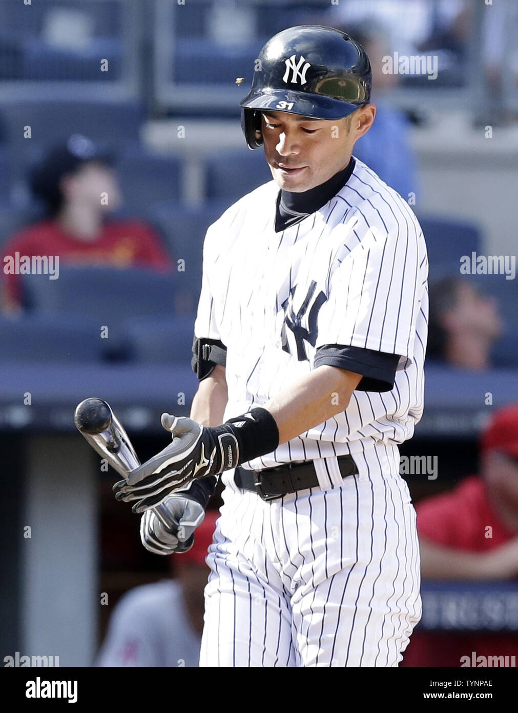 New York Yankees Ichiro Suzuki looks at his bat at the plate when he ...