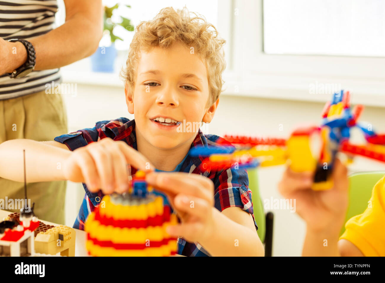 Favourite pastime. Delighted happy boy smiling while doing his ...