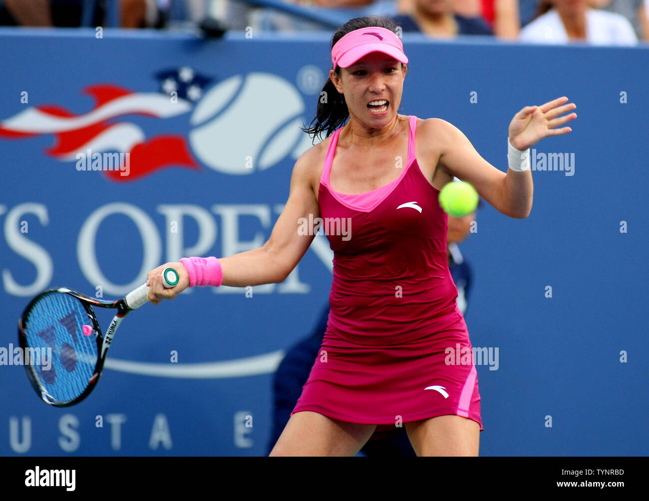 Jie Zheng of China returns the ball to Venus Williams during round-two ...