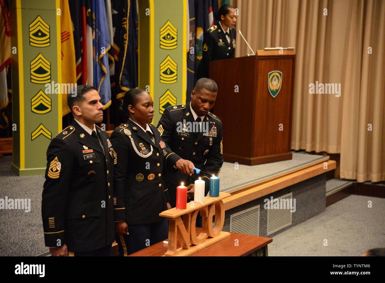 U.S. Army, 1st Sgt. Gary D. Oliver, U.S. Army HQ USANATO, lights a blue ...
