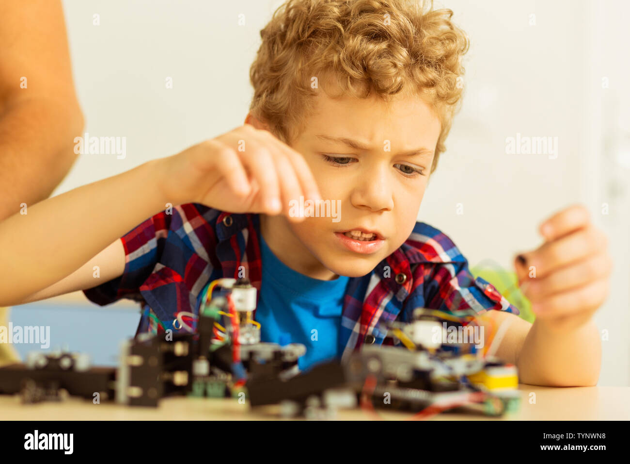 Difficult science. Unhappy cute boy feeling upset while having problems ...