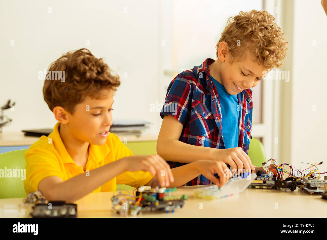 Our common hobby. Happy positive boys having fun while constructing ...