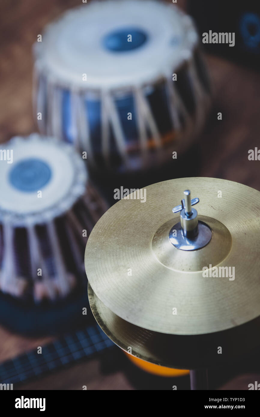 Indian ethnicity man playing the tabla and cajon, percussion ...