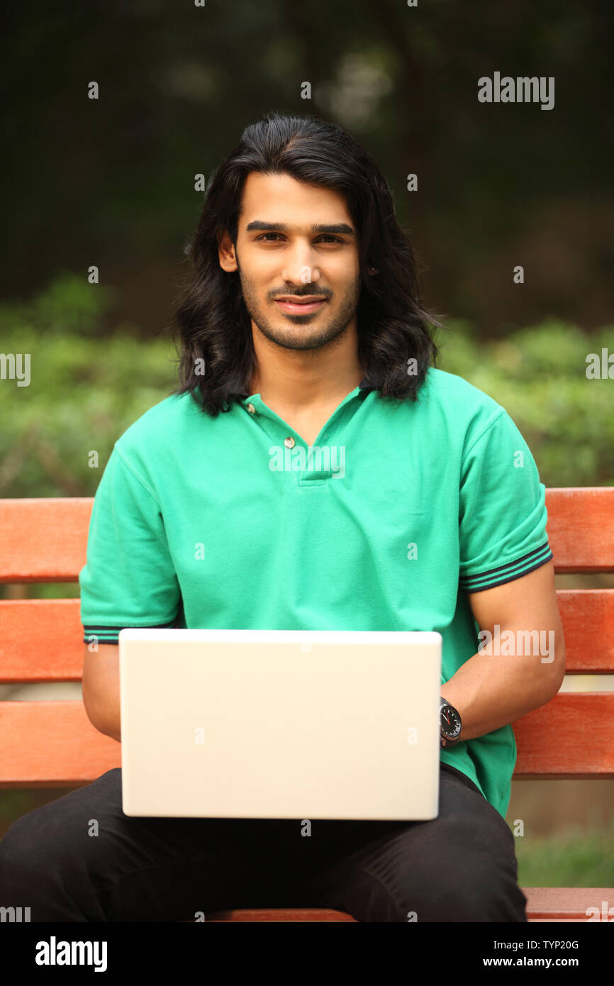 Indian man working on a laptop Stock Photo - Alamy