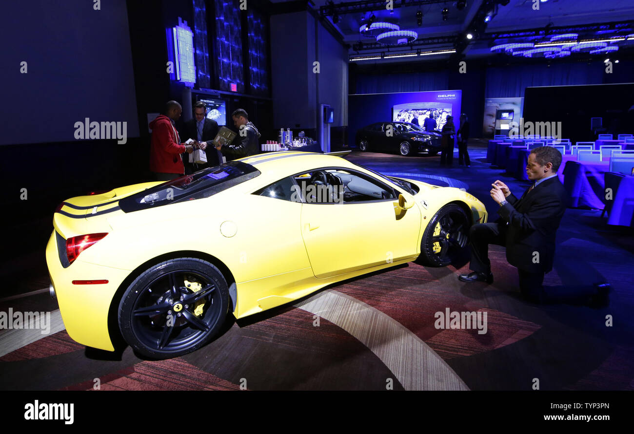 Attendees gather around vehicles for demonstrations when Delphi ...