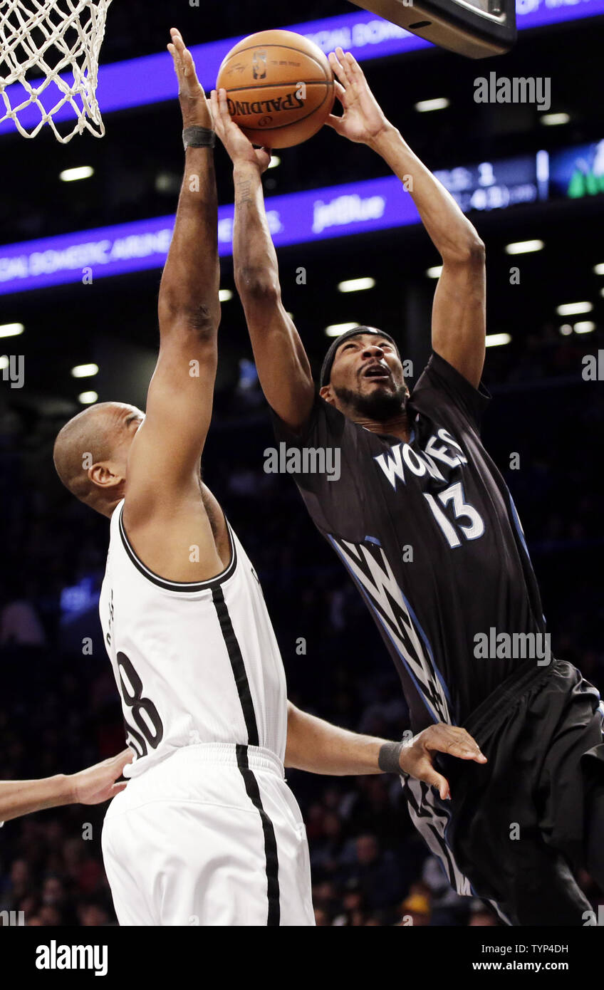 Minnesota Timberwolves Corey Brewer drives to the basket with Brooklyn Nets Jason Collins ...