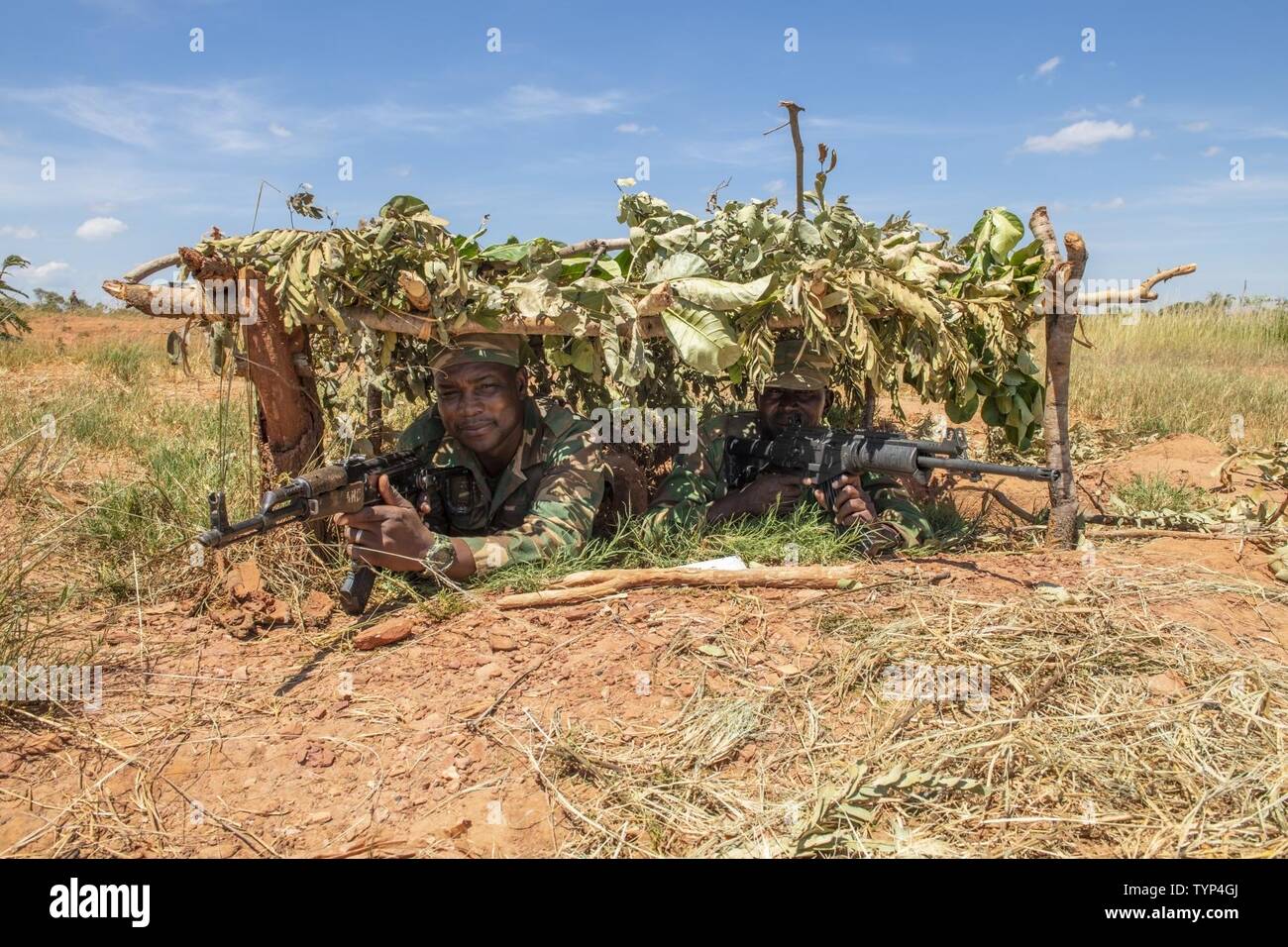 Zambian soldiers guard the perimeter of their outpost from a foxhole ...