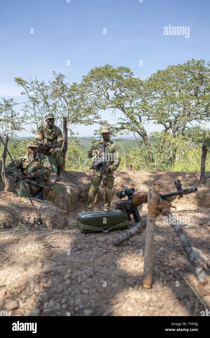 Zambian soldiers guard the perimeter of their outpost from a foxhole ...