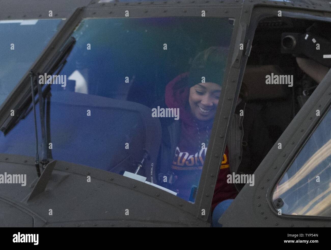 A football fan sits inside a U.S. Army Black Hawk from Bravo Company ...