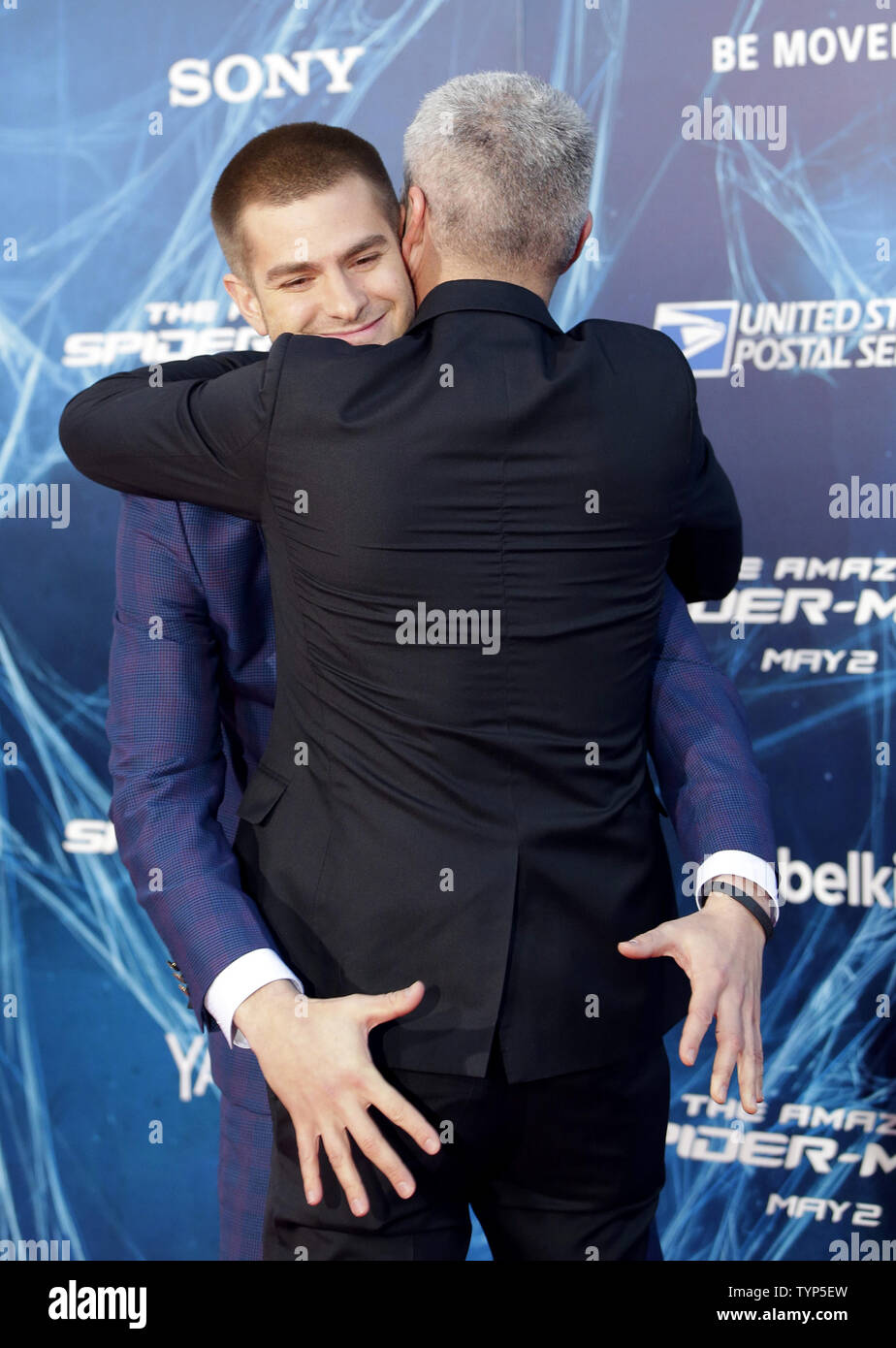 Andrew Garfield hugs producer Matthew Tolmach when they arrive on the ...
