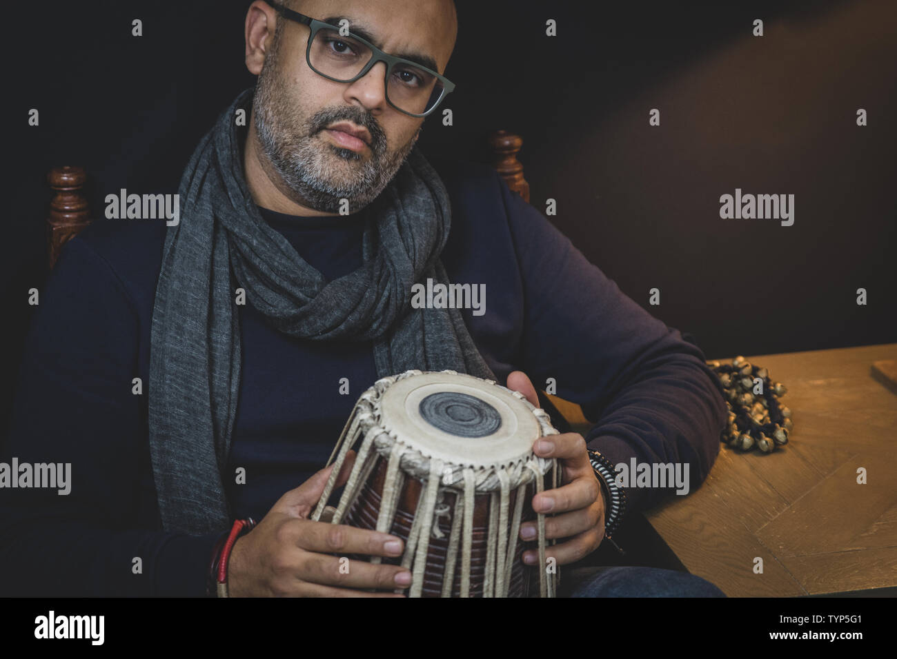 Indian ethnicity man playing the tabla and cajon, percussion ...