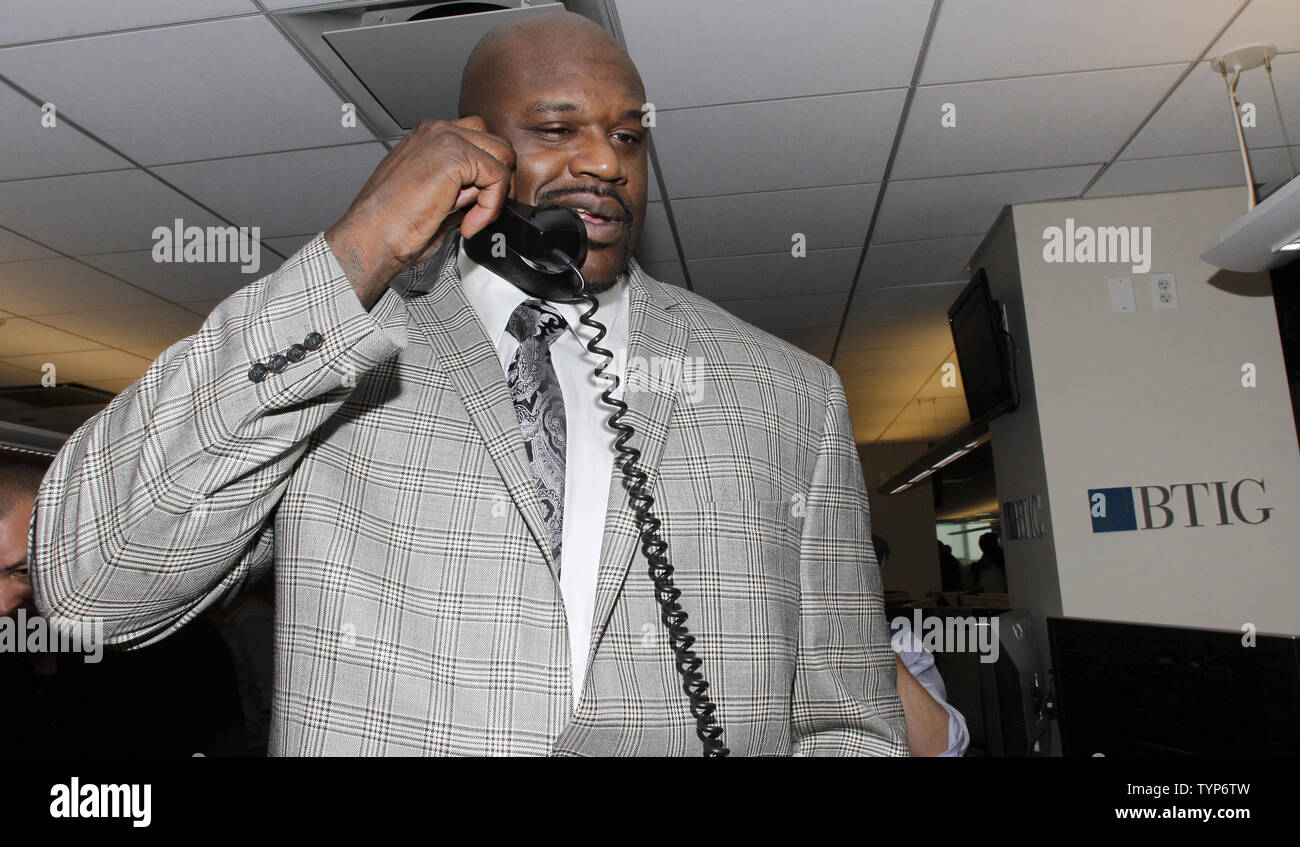 Former NBA player Shaquille O'Neal speaks to a client on the phone at ...