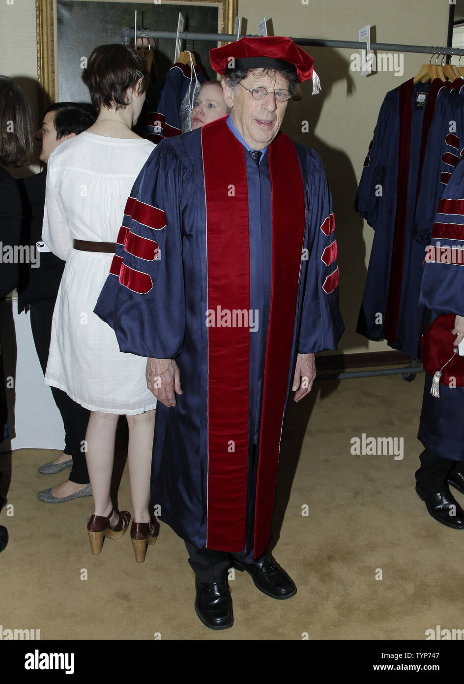 Composer Philip Glass stands in a cap and gown before receiving an ...