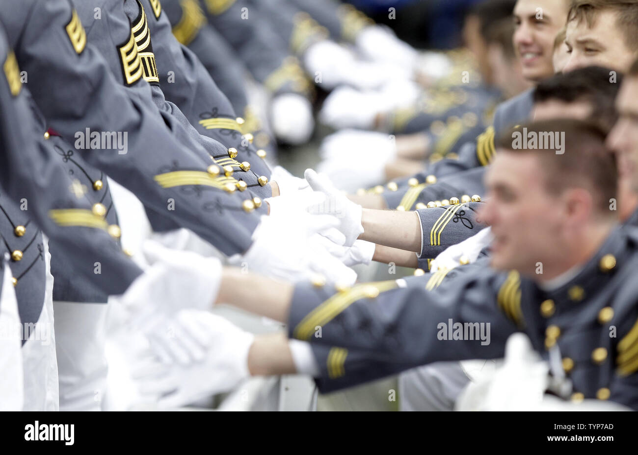 Cadets slap hands as the walk from the benches to receive their ...