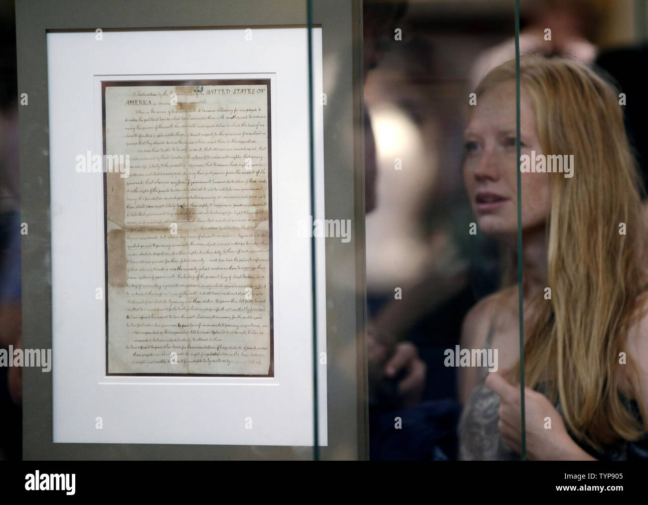 A woman looks at a rare historic copy of the Declaration of ...