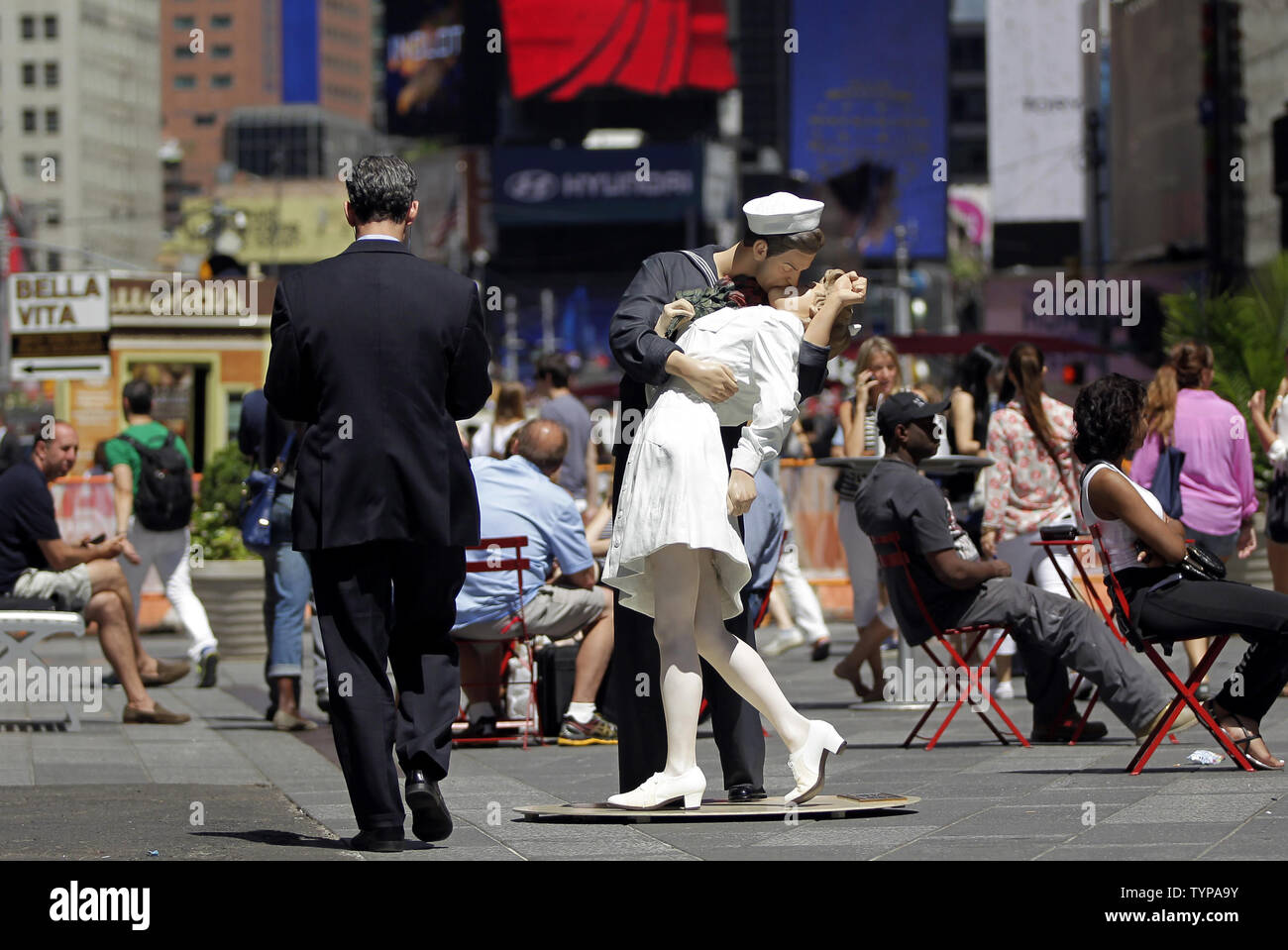 A man walks by a six foot statue statue depicting Alfred Eisenstaedt's ...