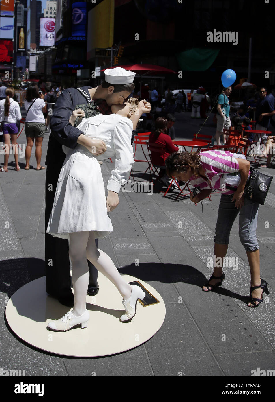 A woman stops to look at a six foot statue statue depicting Alfred ...