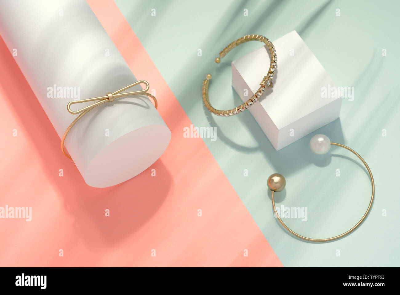 Modern design Golden bracelets on pastel color paper background Stock ...