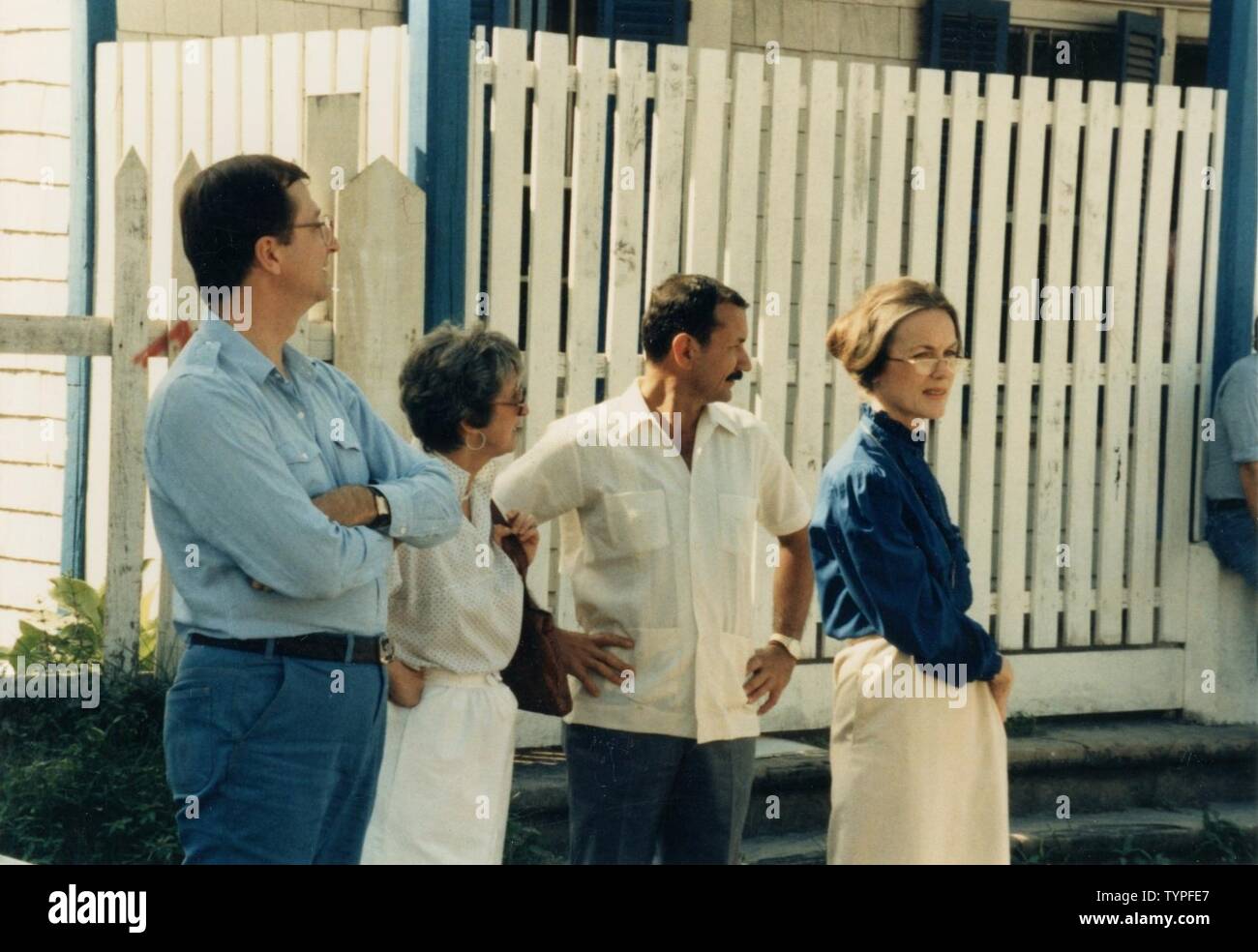 Two women and men viewing something. Construction Stock Photo - Alamy