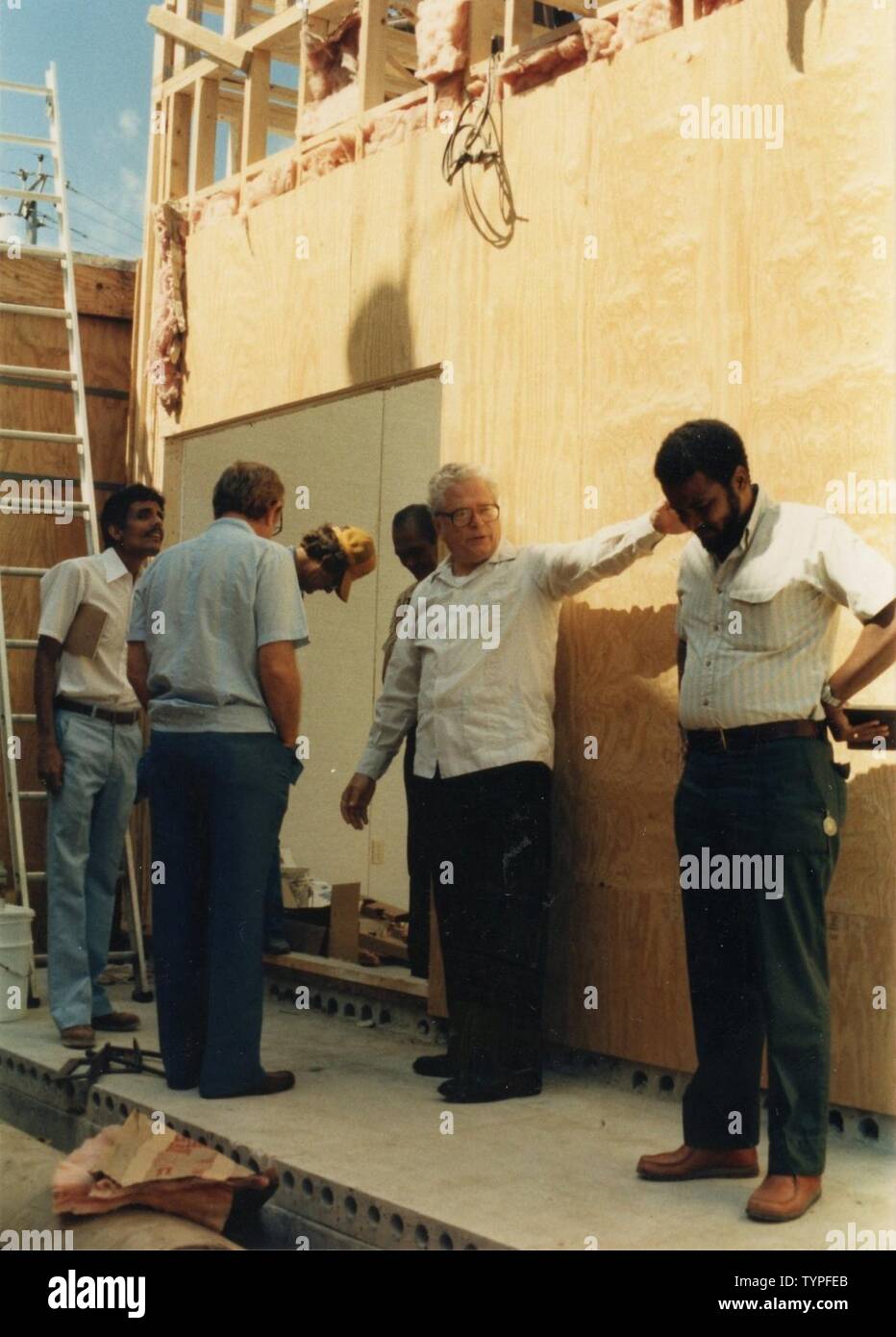 Group of men observing construction Stock Photo - Alamy