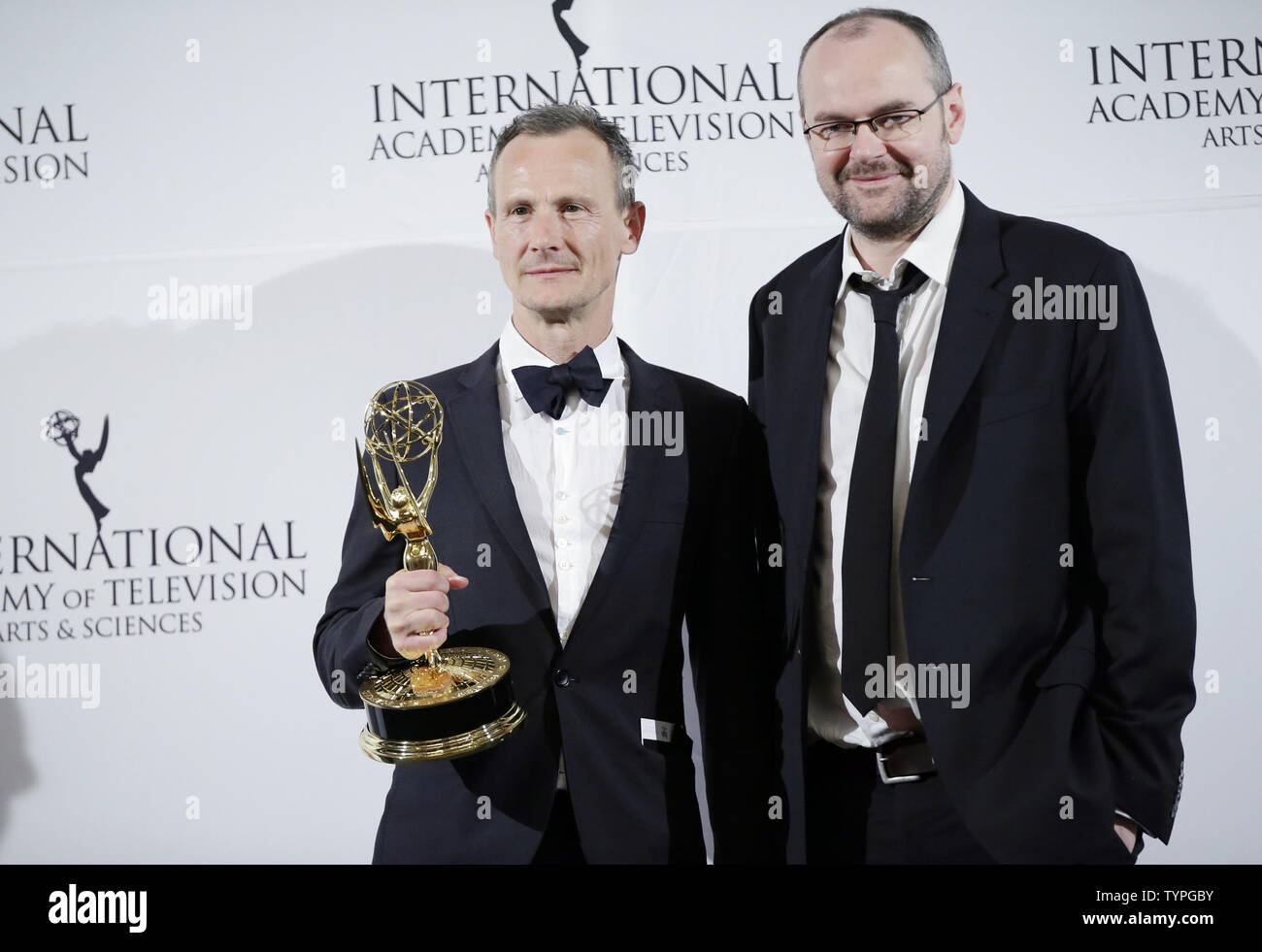 Marc Munden and Dennis Kelly arrive in the press room at the 2014 ...