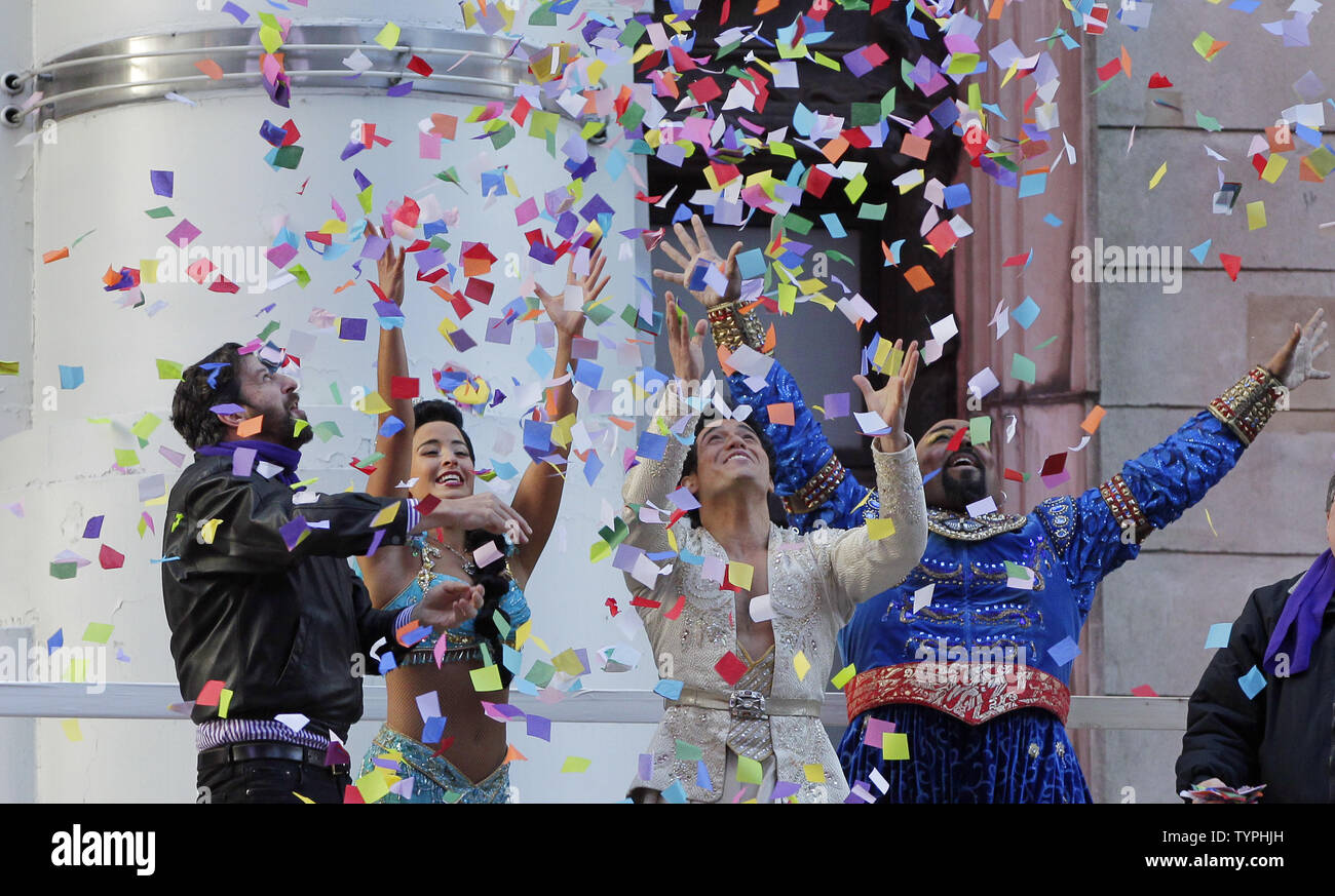 The cast of Aladdin on Broadway and event organizers toss confetti from ...