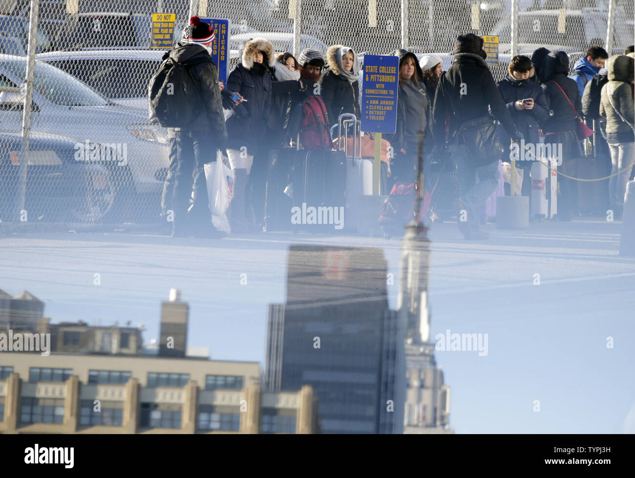 The reflection of Empire State Building through a mirror is below a ...