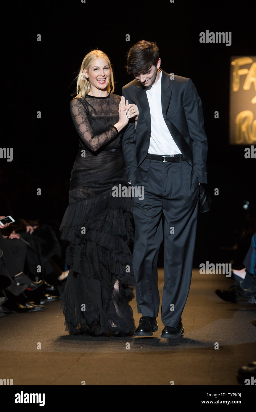 Kelly Rutherford (L) and a model walk on the runway at Naomi Campbell's ...