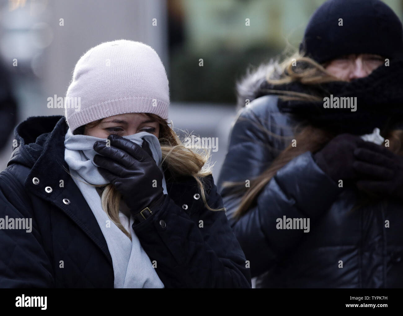 A woman bundled up for freezing cold weather walks on Sixth Avenue in ...