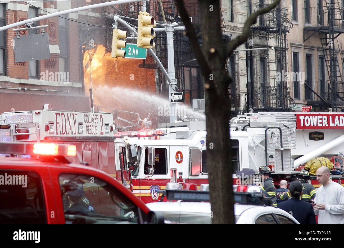 FDNY firefighters put water on a building that is on fire in New York ...